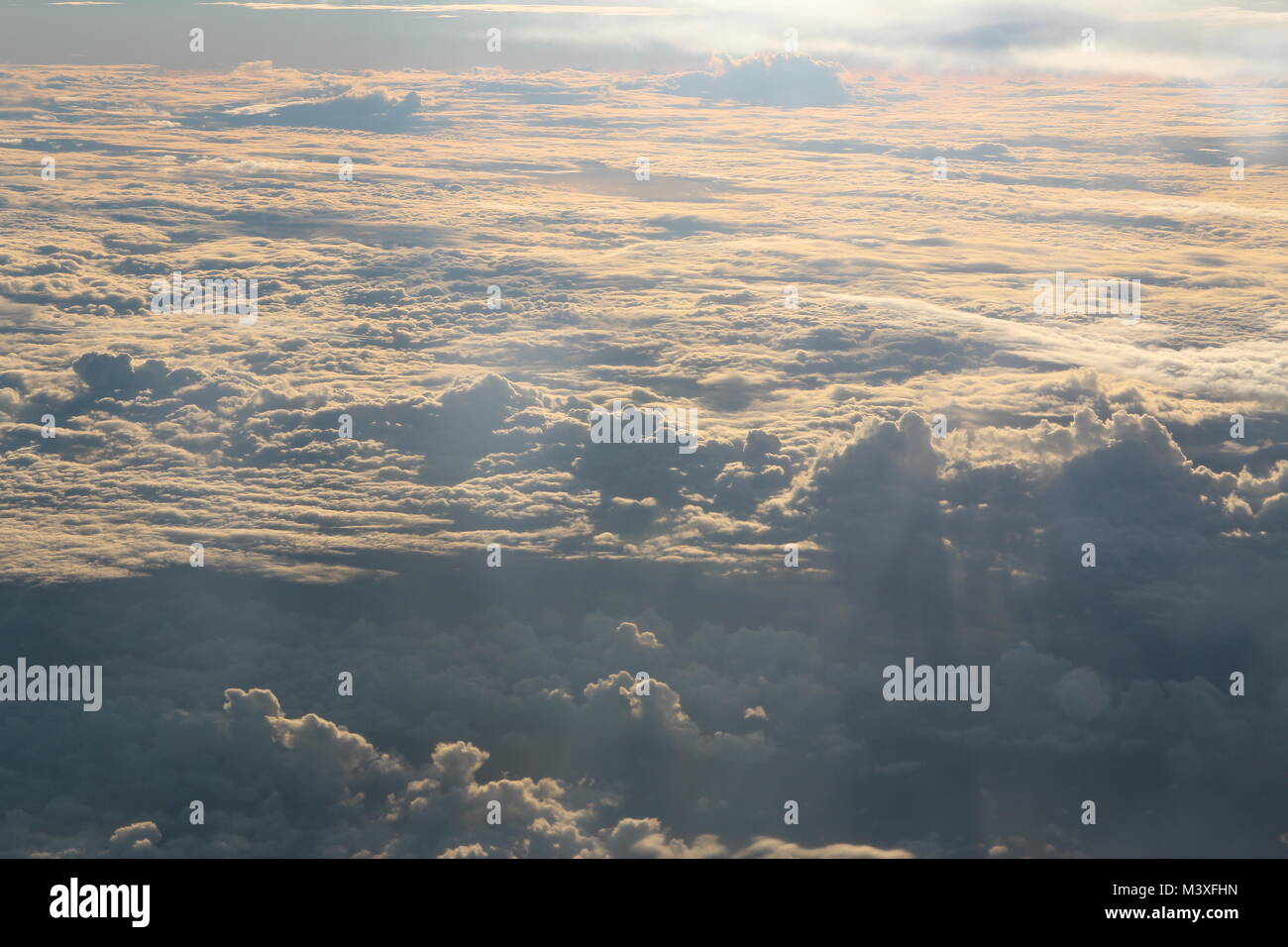 Cloud texture and blue sky during sunrise viewed from airplane Stock ...