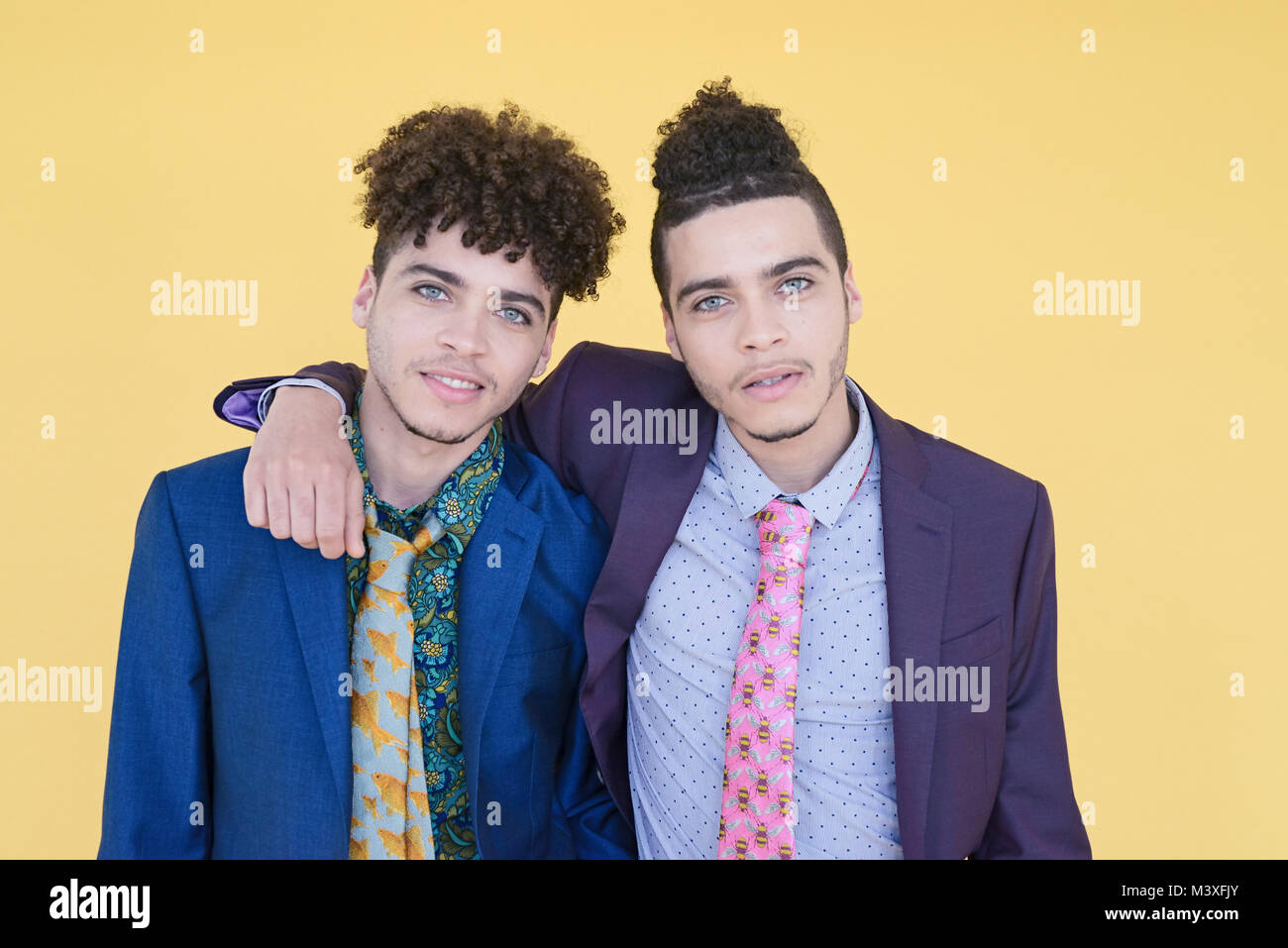 Two handsome mixed race boys (twins) with blue eyes and afro hair wear ...