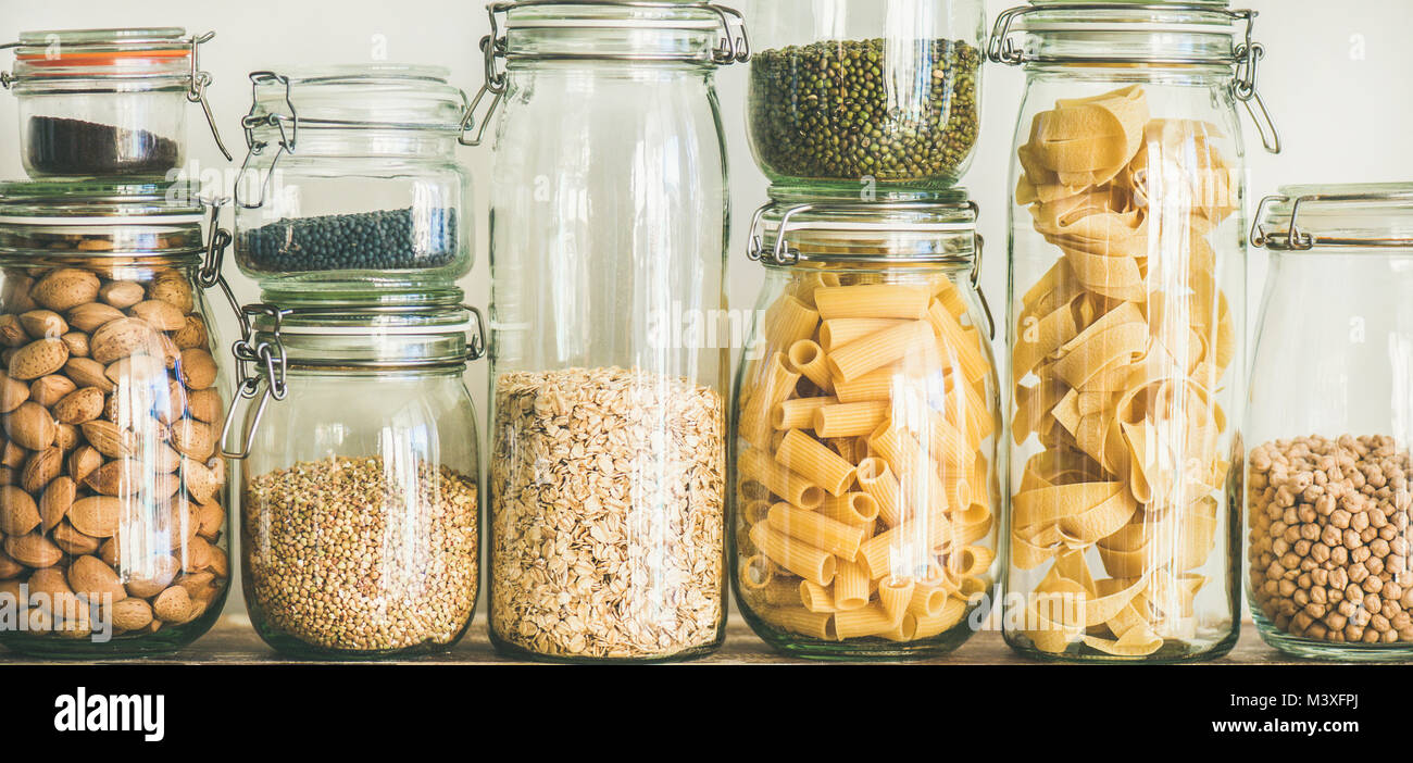 Uncooked cereals, grains, beans and pasta on rustic table, close-up ...