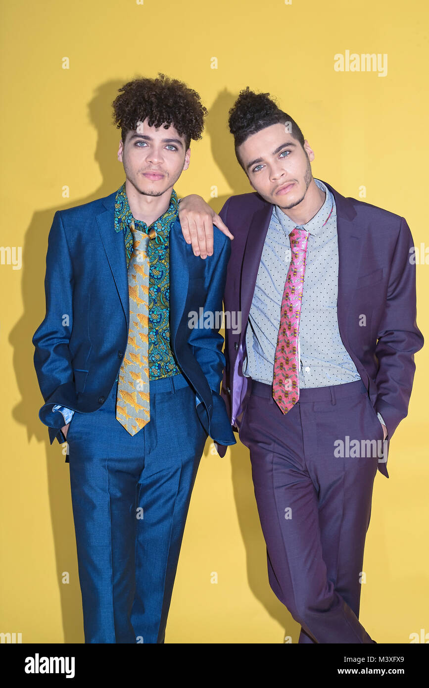 Two handsome mixed race boys (twins) with blue eyes and afro hair wear ...