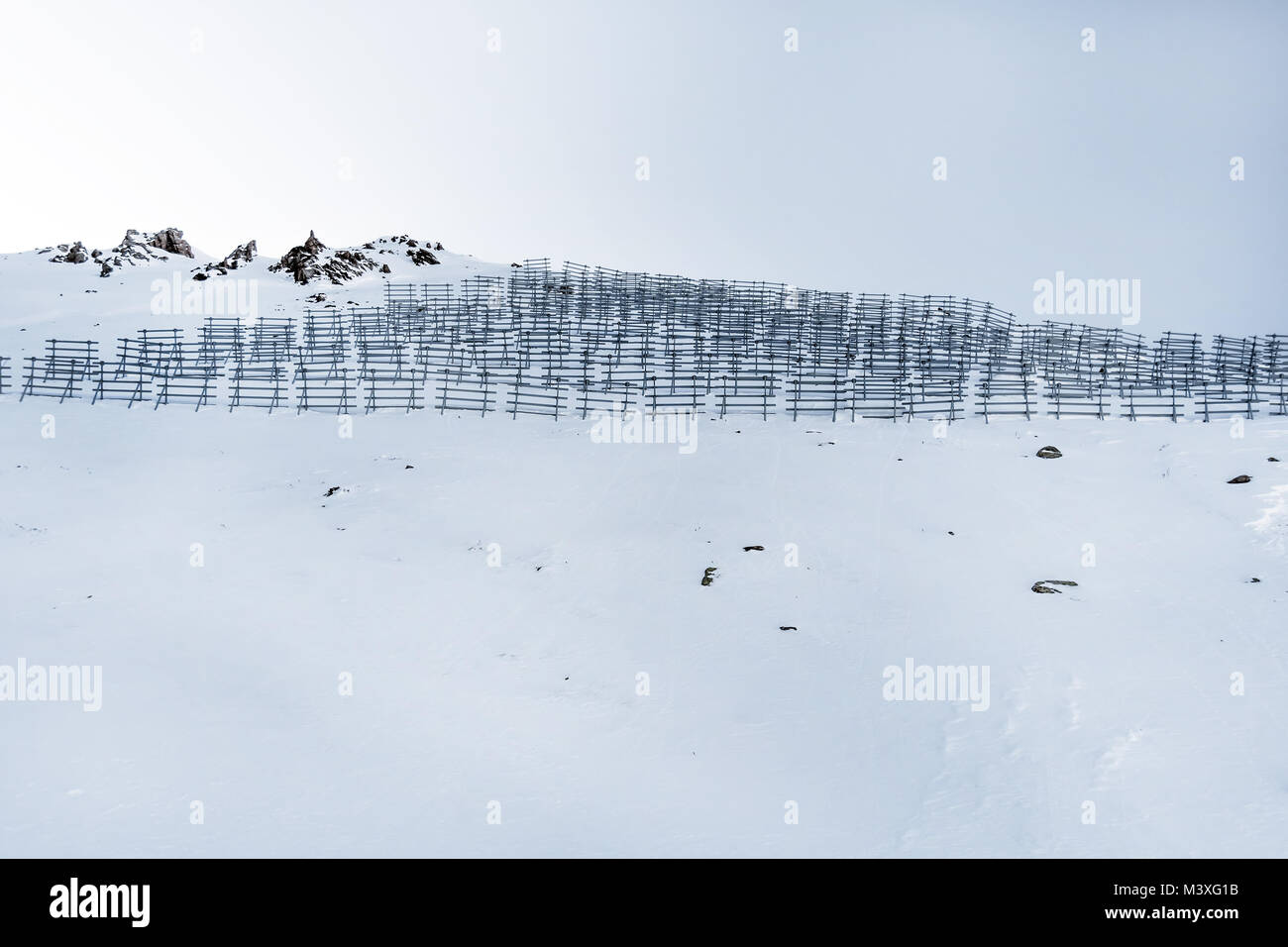 Avalanche protection construction on top of a mountain in winter. Snowy ...