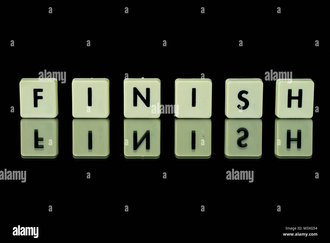 scrabble set on a glass table. Words arranged from letters on a glass ...