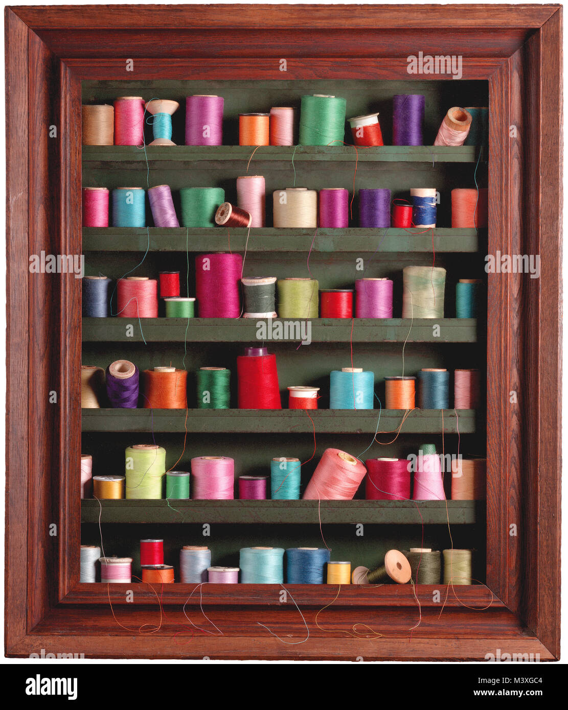 Sewing spools in frame, vertical color photograph of various vintage ...