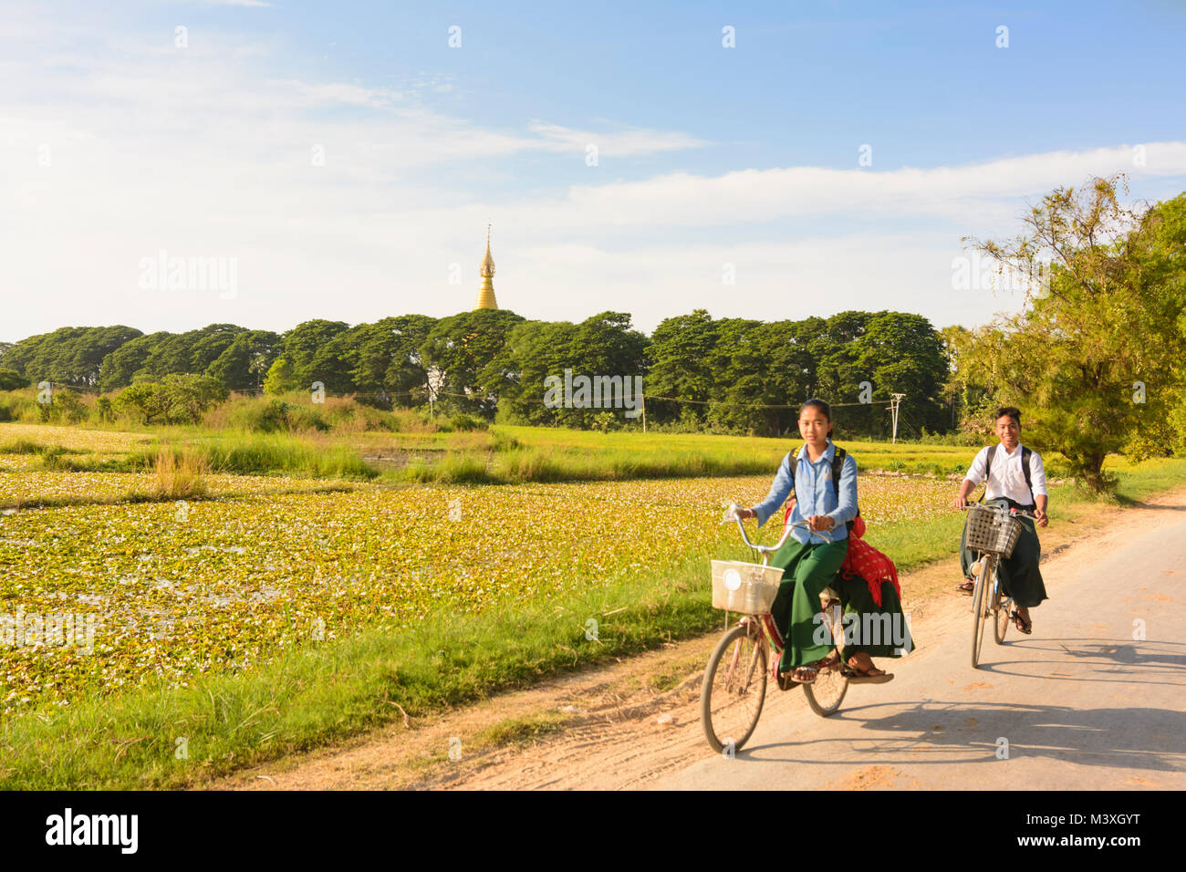 Inwa (Ava): school kids, bicycle, stupa, , Mandalay Region, Myanmar ...