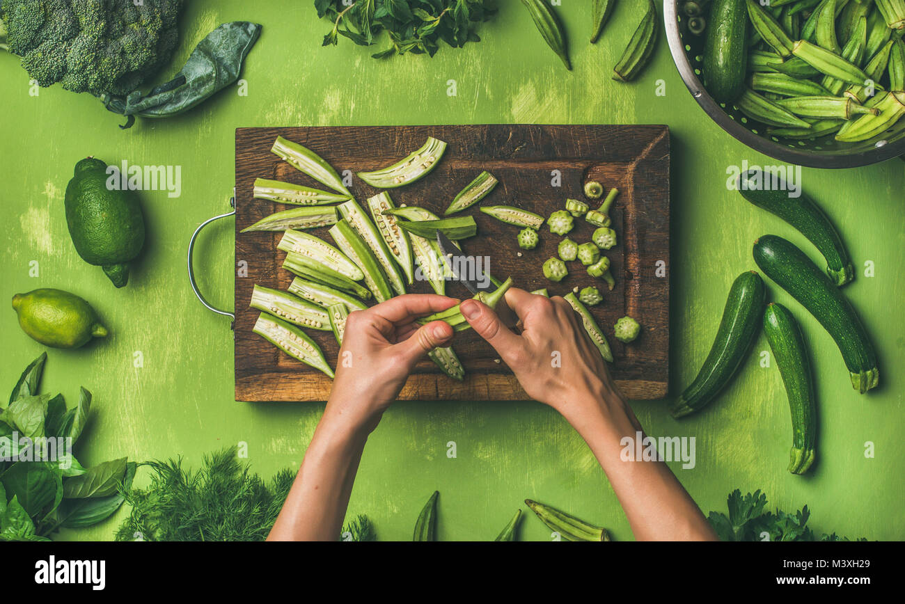 Flat-lay of healthy green vegan cooking ingredients over green ...
