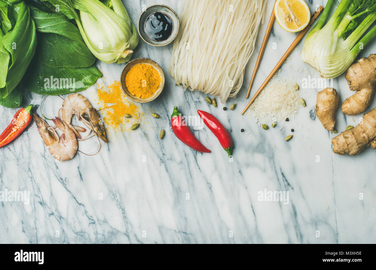 Flat-lay of Asian cuisine ingredients over marble background, copy ...