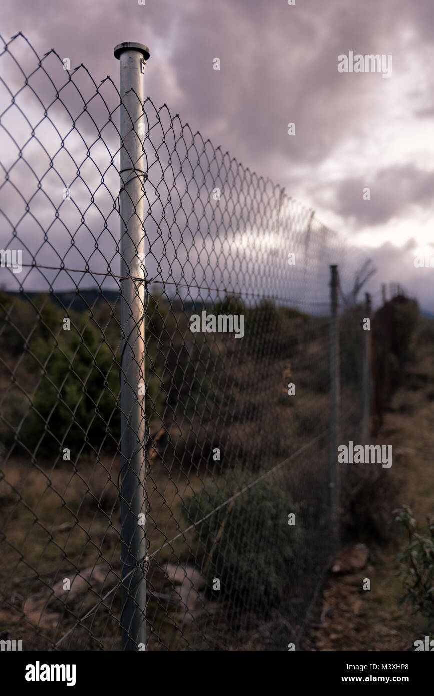 Apocalyptic scene of barbed wire fence and cloudy sky Stock Photo - Alamy