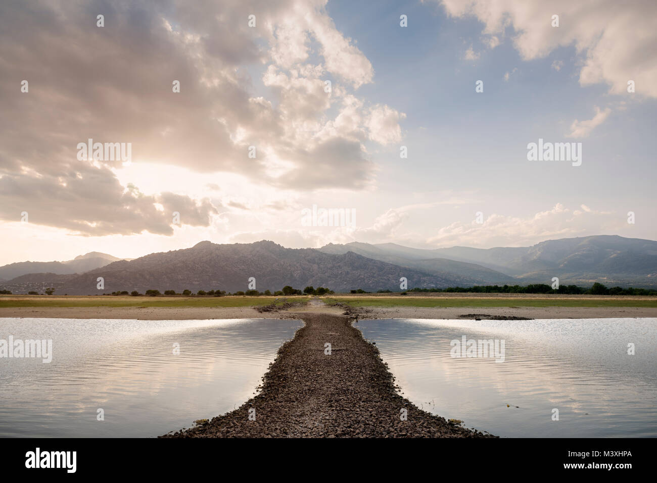Symmetrical road landscape in the middle of the lake on a beautiful ...