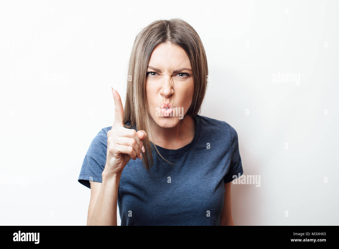 Close up isolated portrait of young annoyed angry woman holding hands ...