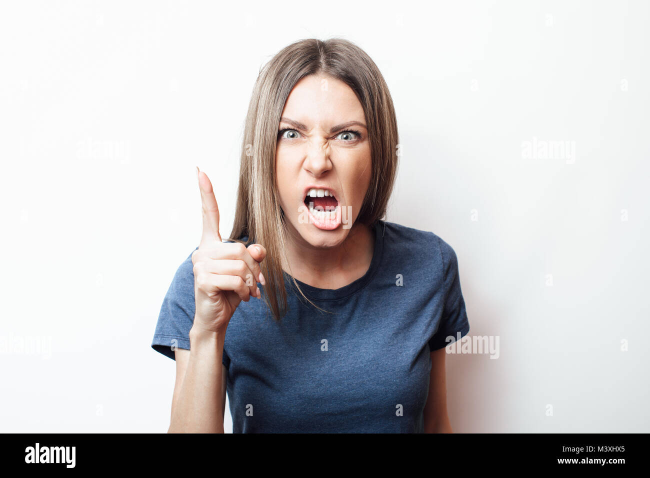 Close up isolated portrait of young annoyed angry woman holding hands ...