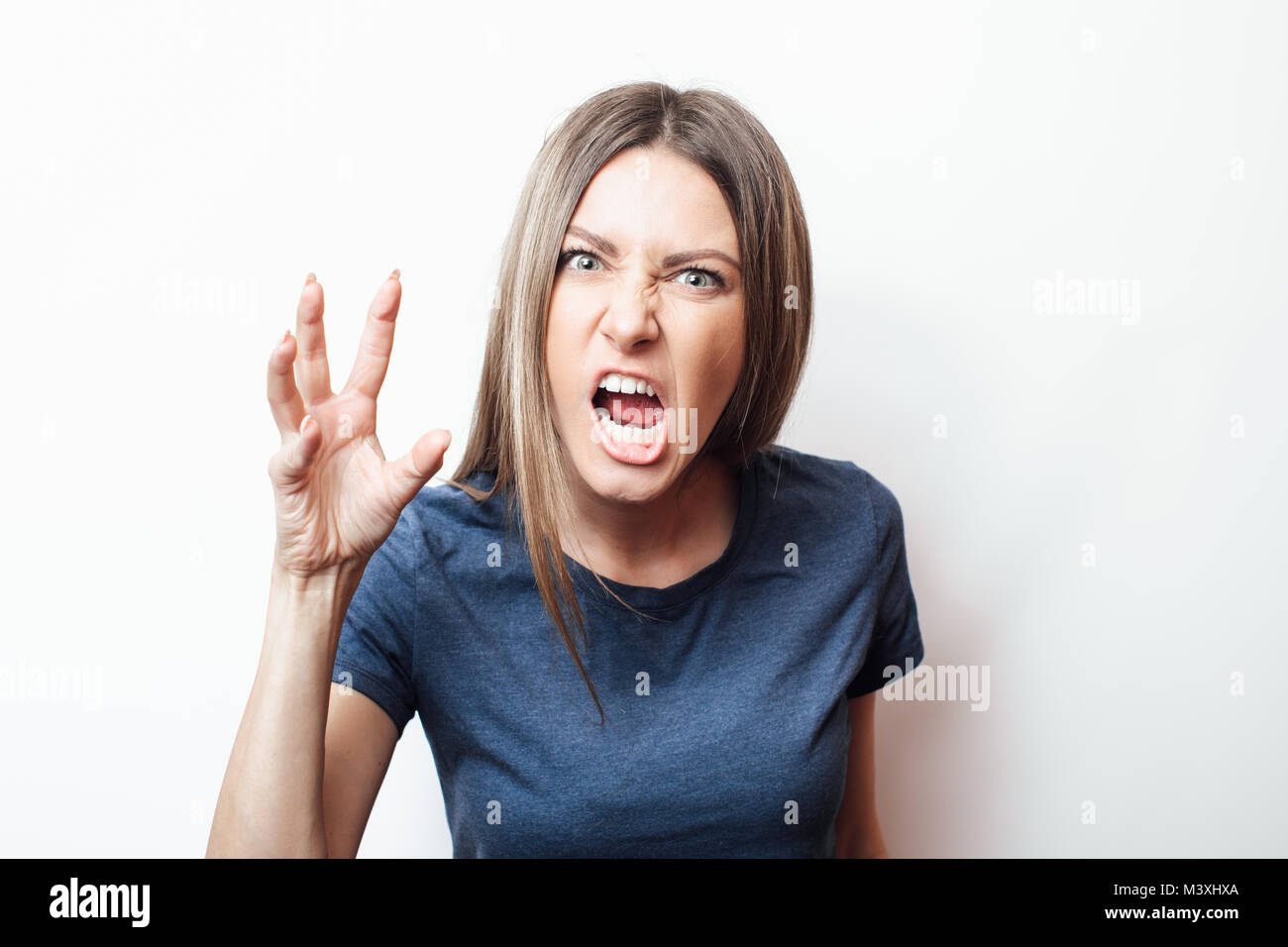 Close up isolated portrait of young annoyed angry woman holding hands ...
