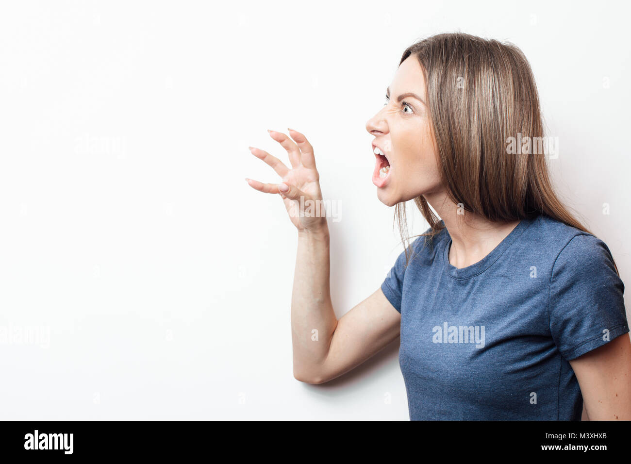 Close up isolated portrait of young annoyed angry woman holding hands ...