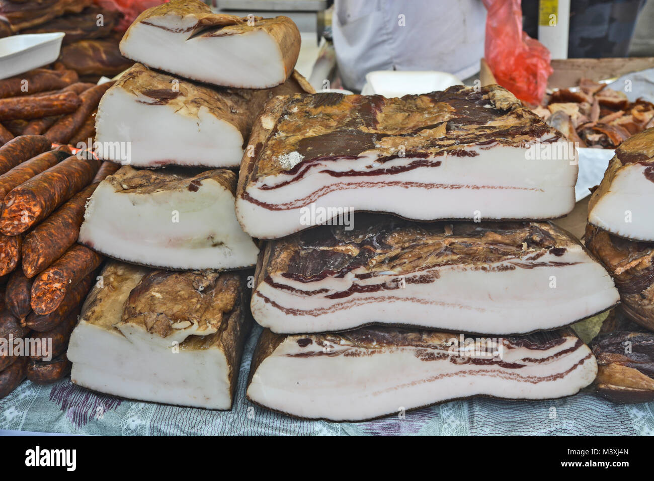 Street sale of exposed domestic bacon products and sausages Stock Photo ...