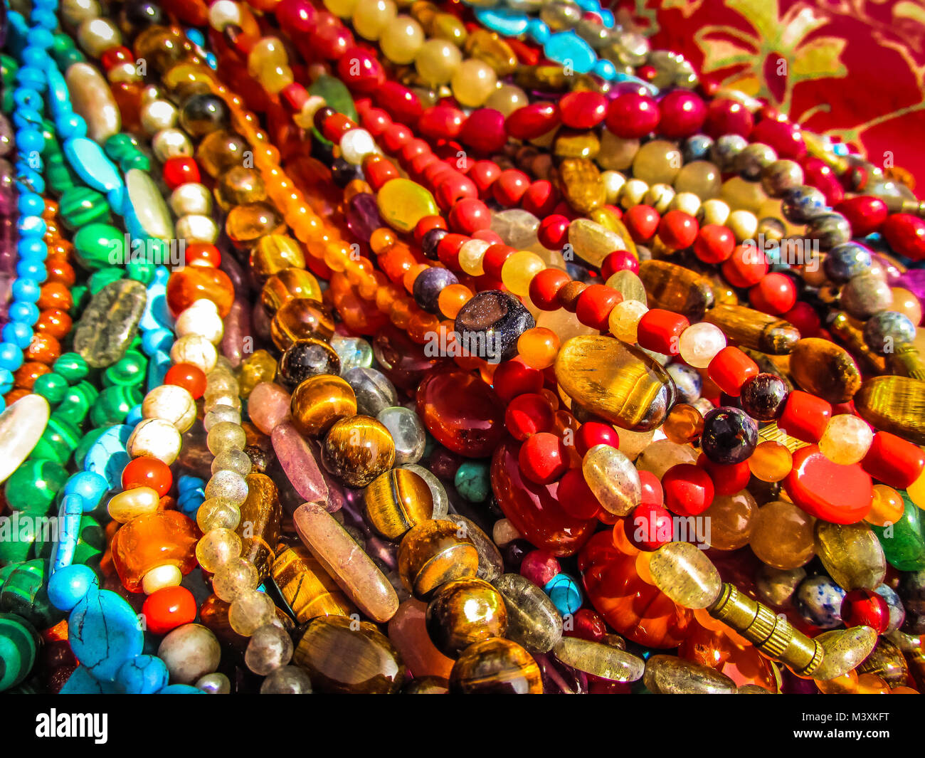 Colorful jewelry sold on the beach in southern India Stock Photo - Alamy