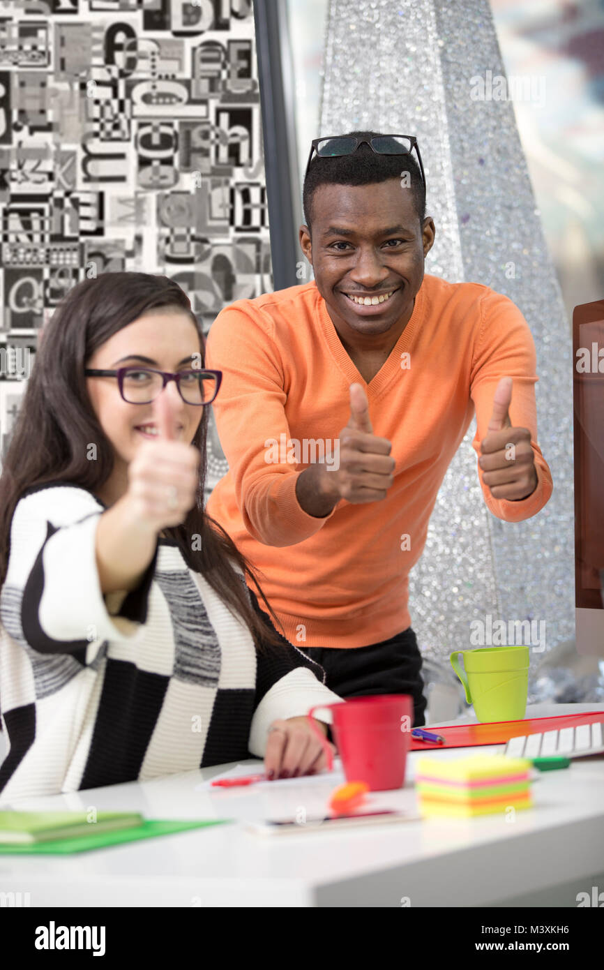 business, startup and office concept - happy creative team showing ...