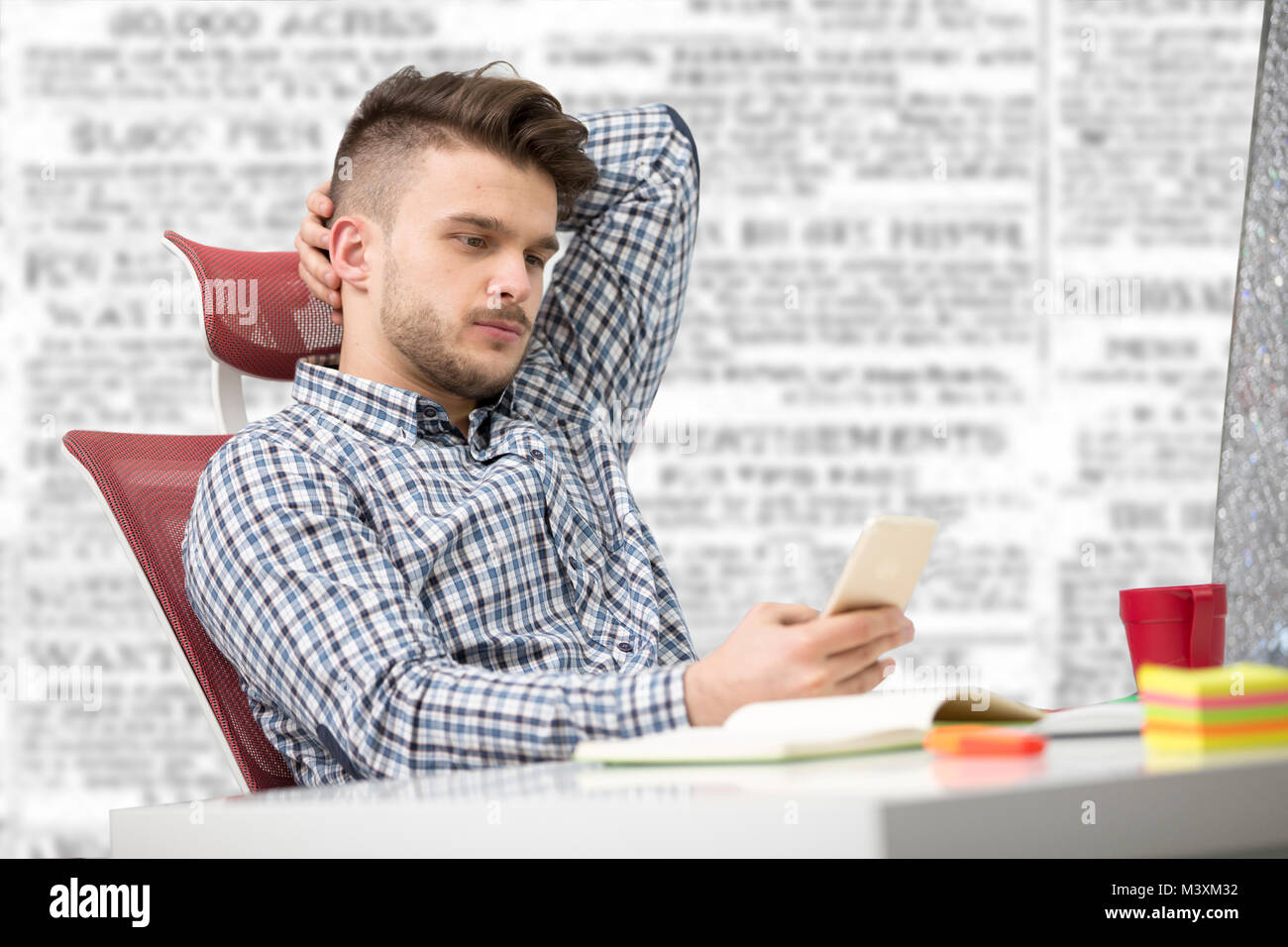Young happy businessman smiling while reading his smartphone Stock ...