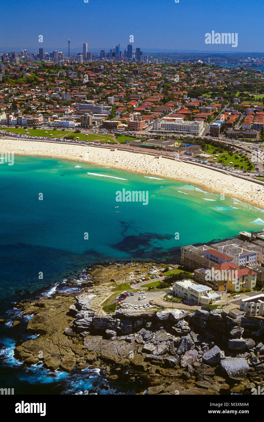 An aerial view of Bondi Beach with the Sydney city skyline in the ...