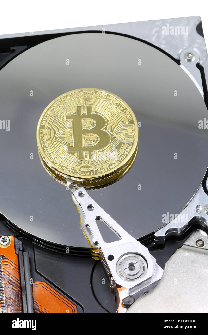 golden coin of BITCOIN on a computer hard drive Stock Photo - Alamy