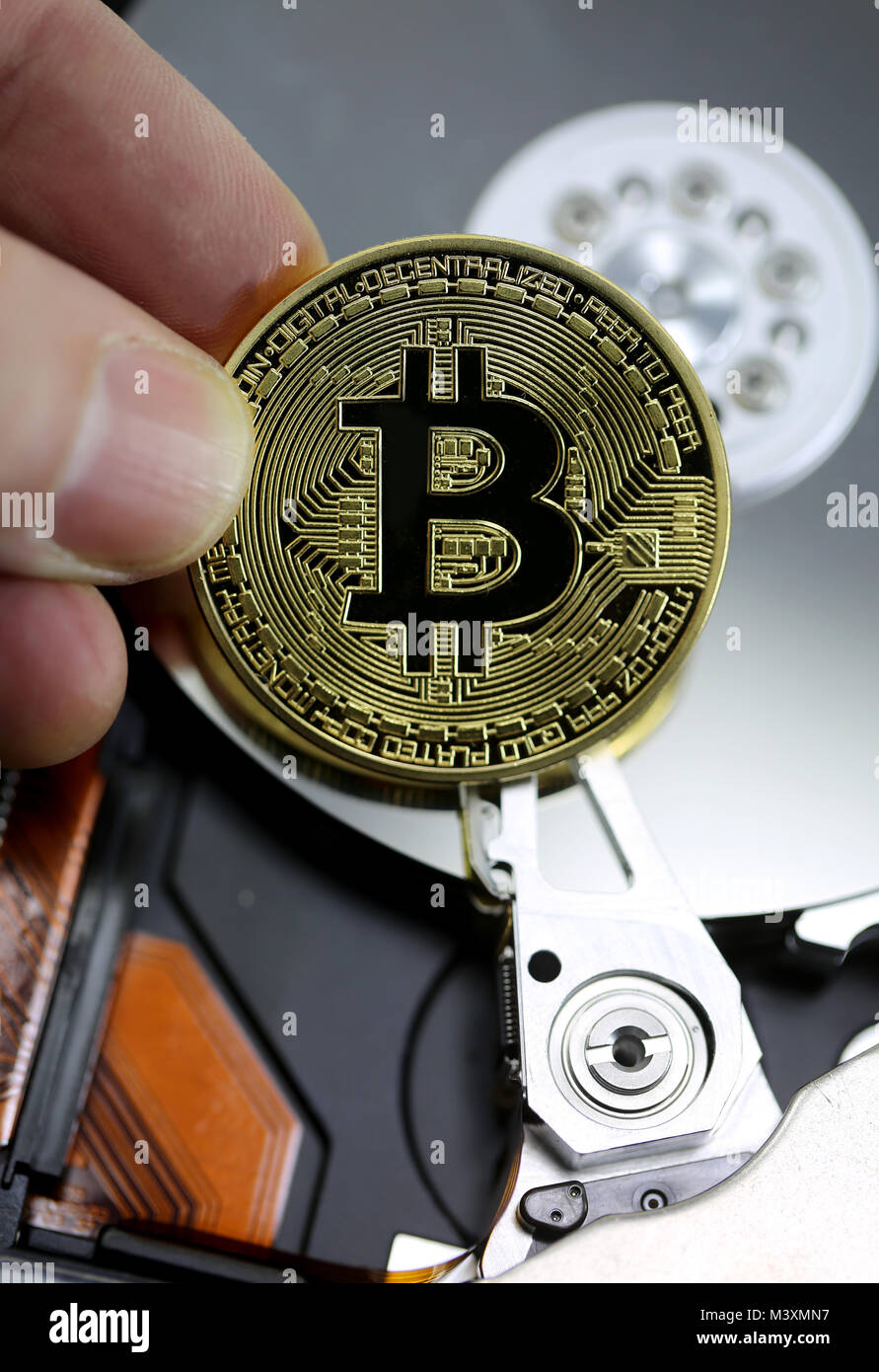 hand holds the big golden coin of BITCOIN symbol of the new crypto ...