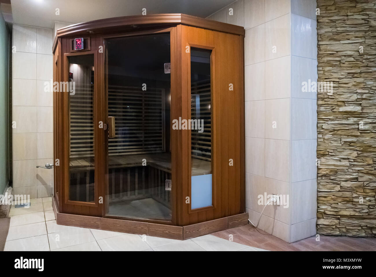 a small wooden infrarered sauna booth in a spa. Infrared Saina cabin in ...