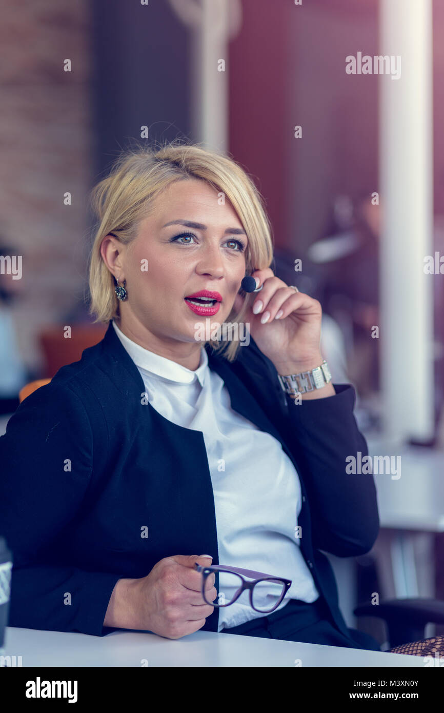 Smiling agent woman with headsets. Portrait of call center worker at office Stock Photo - Alamy