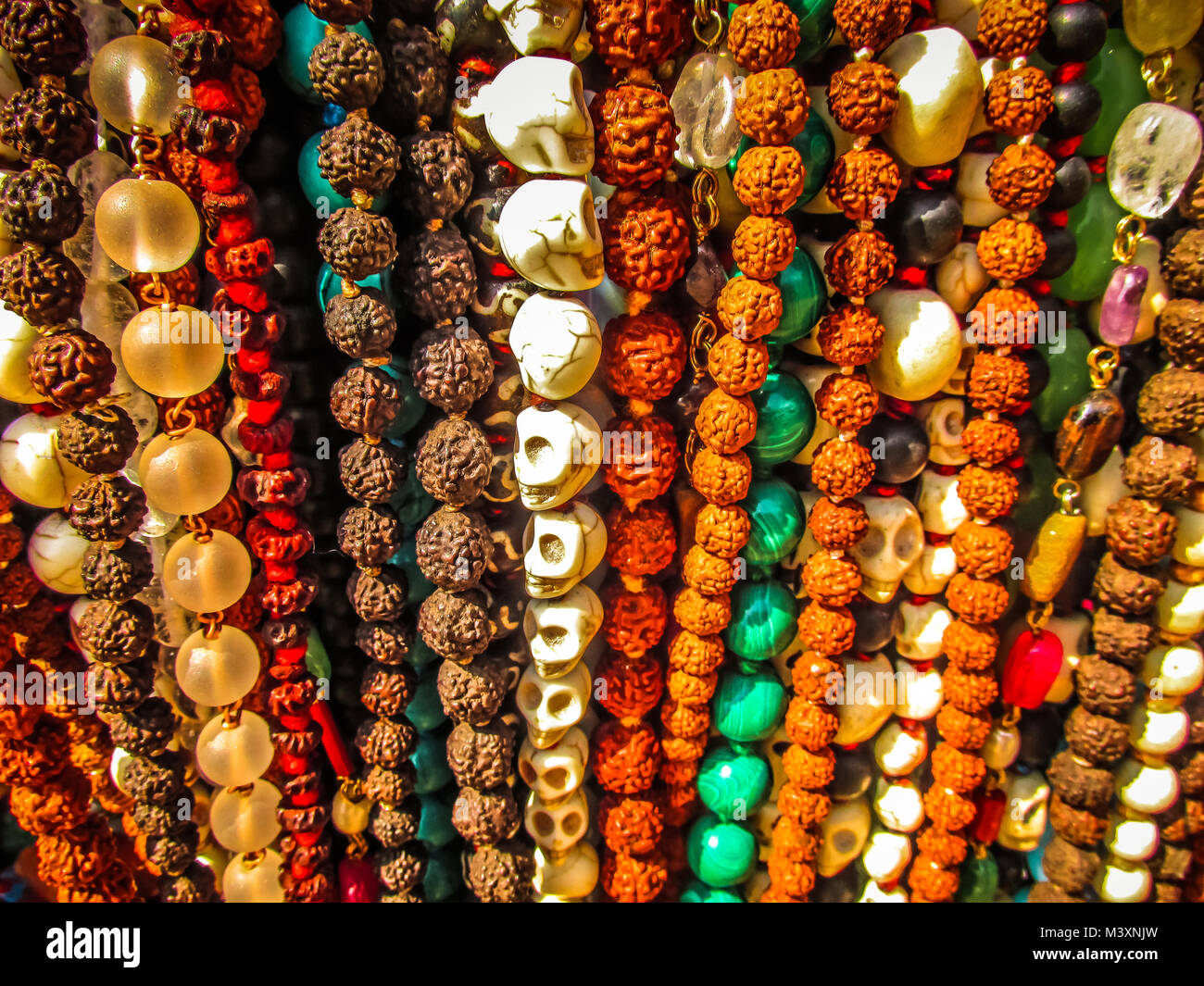 Colorful jewelry sold on the beach in southern India Stock Photo - Alamy