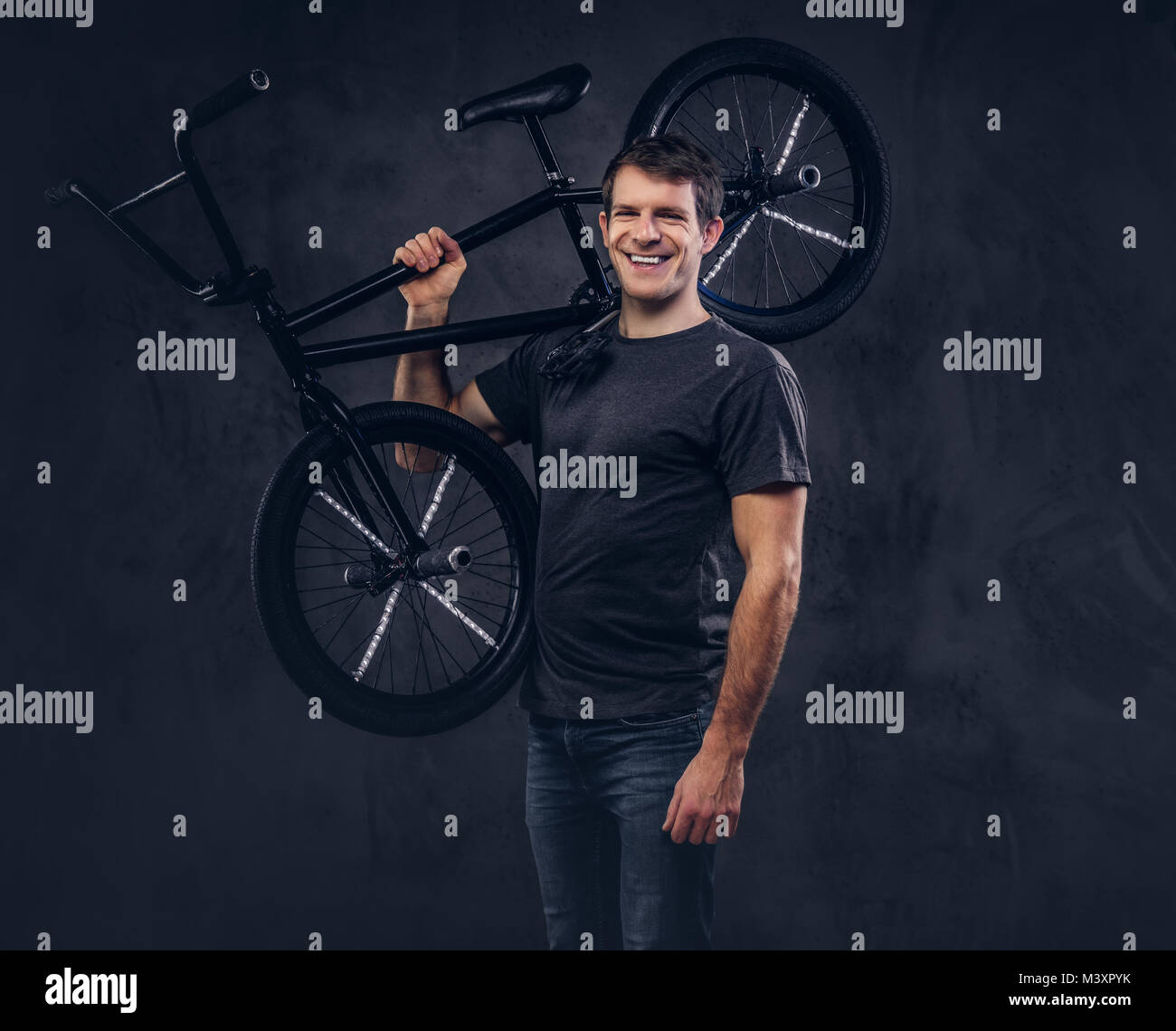 A handsome man with BMX in a studio Stock Photo - Alamy