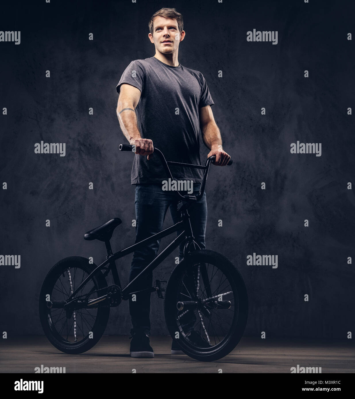 A handsome man with BMX in a studio Stock Photo - Alamy