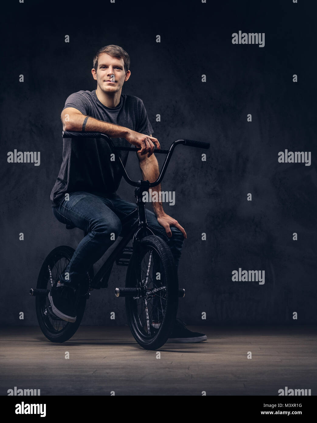 A handsome man with BMX in a studio Stock Photo - Alamy