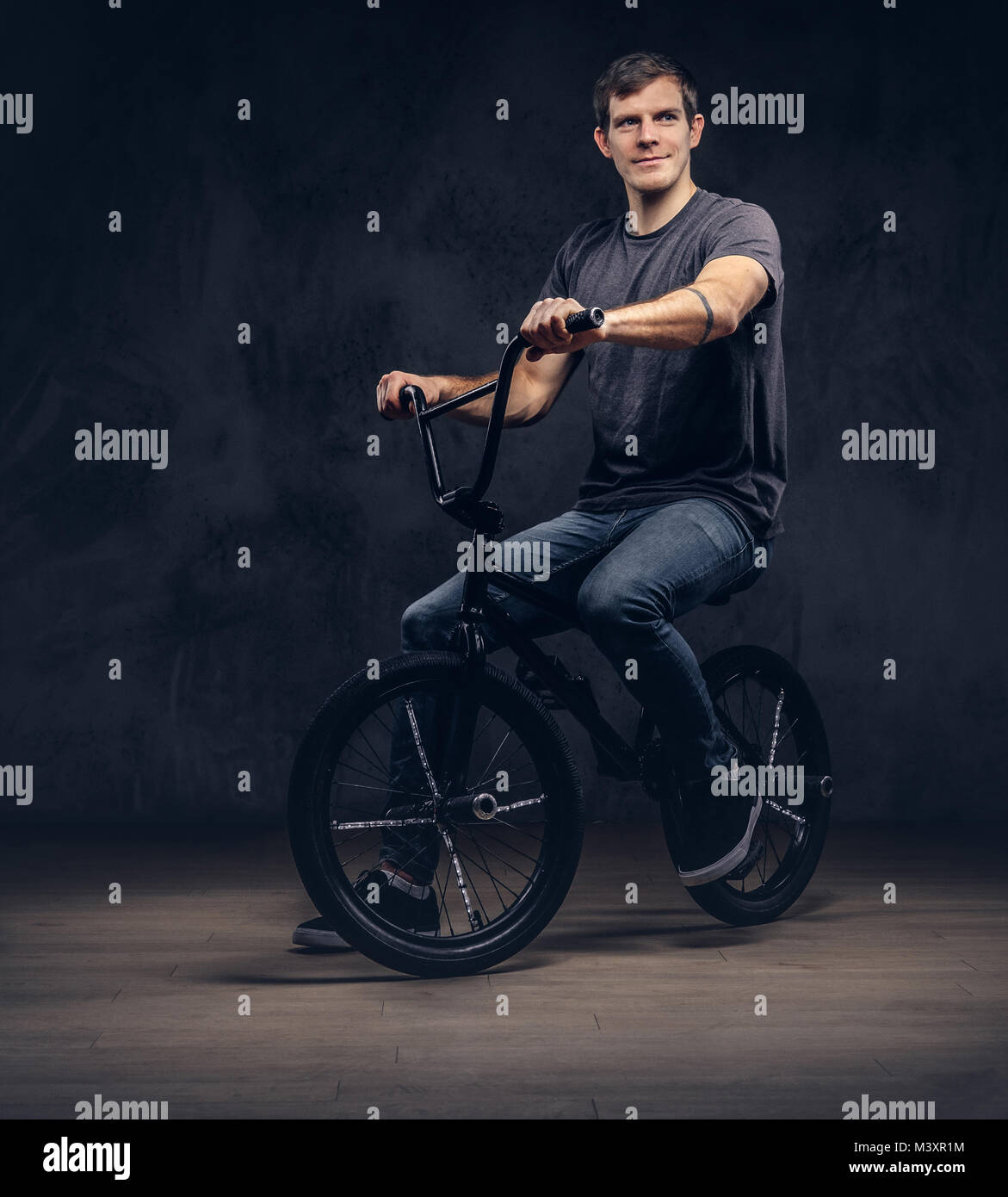 A handsome man with BMX in a studio Stock Photo - Alamy
