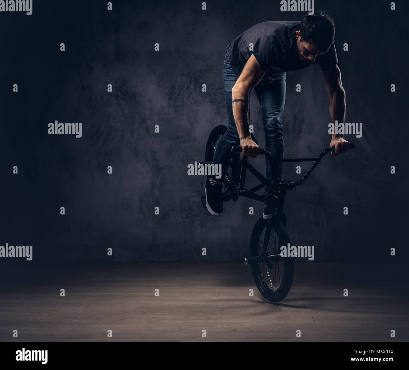 A handsome man with BMX in a studio Stock Photo - Alamy