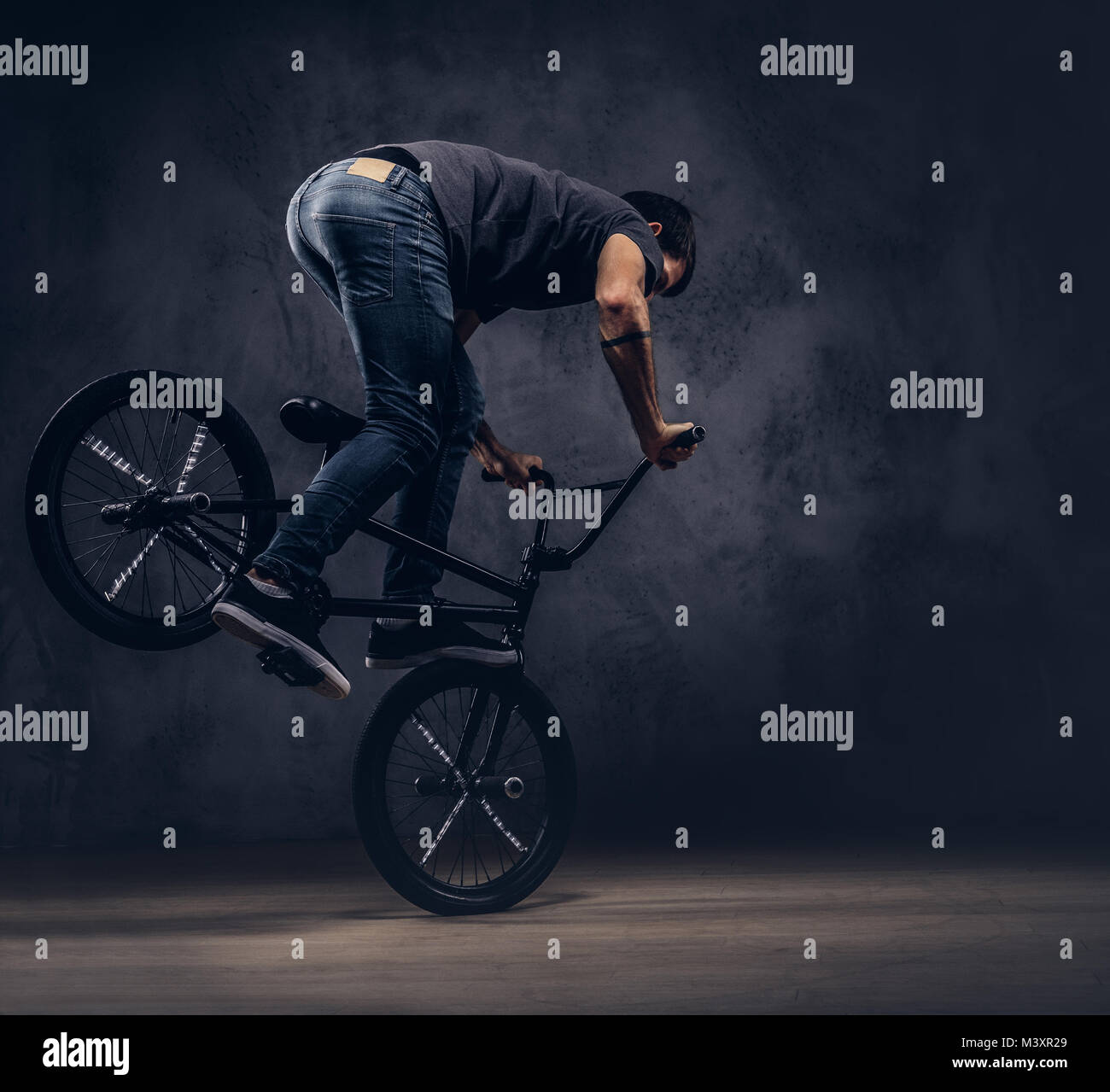 A handsome man with BMX in a studio Stock Photo - Alamy