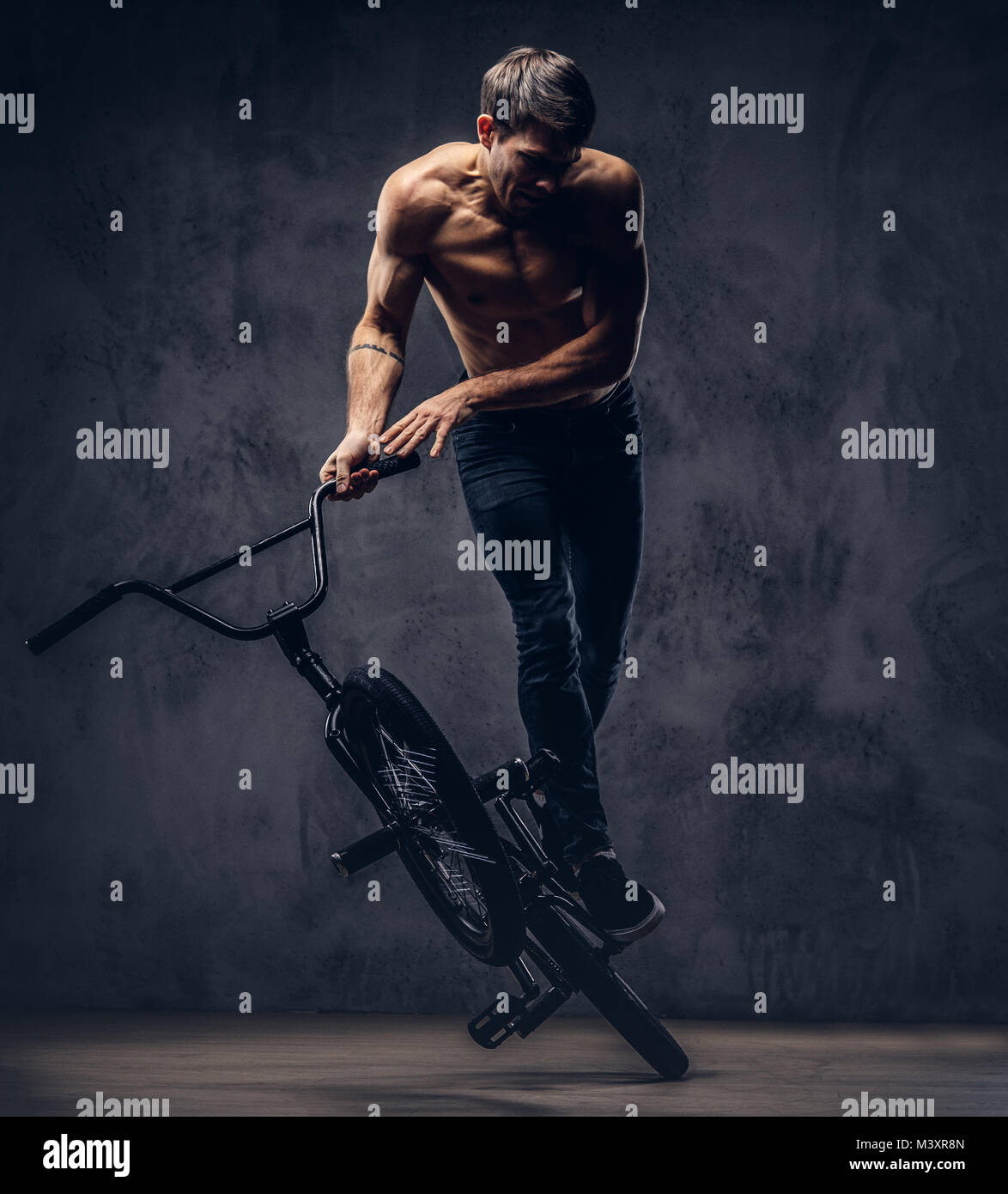 A handsome man with BMX in a studio Stock Photo - Alamy