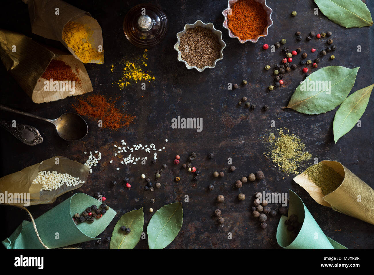 Different food spices scattered on a dark surface Stock Photo - Alamy