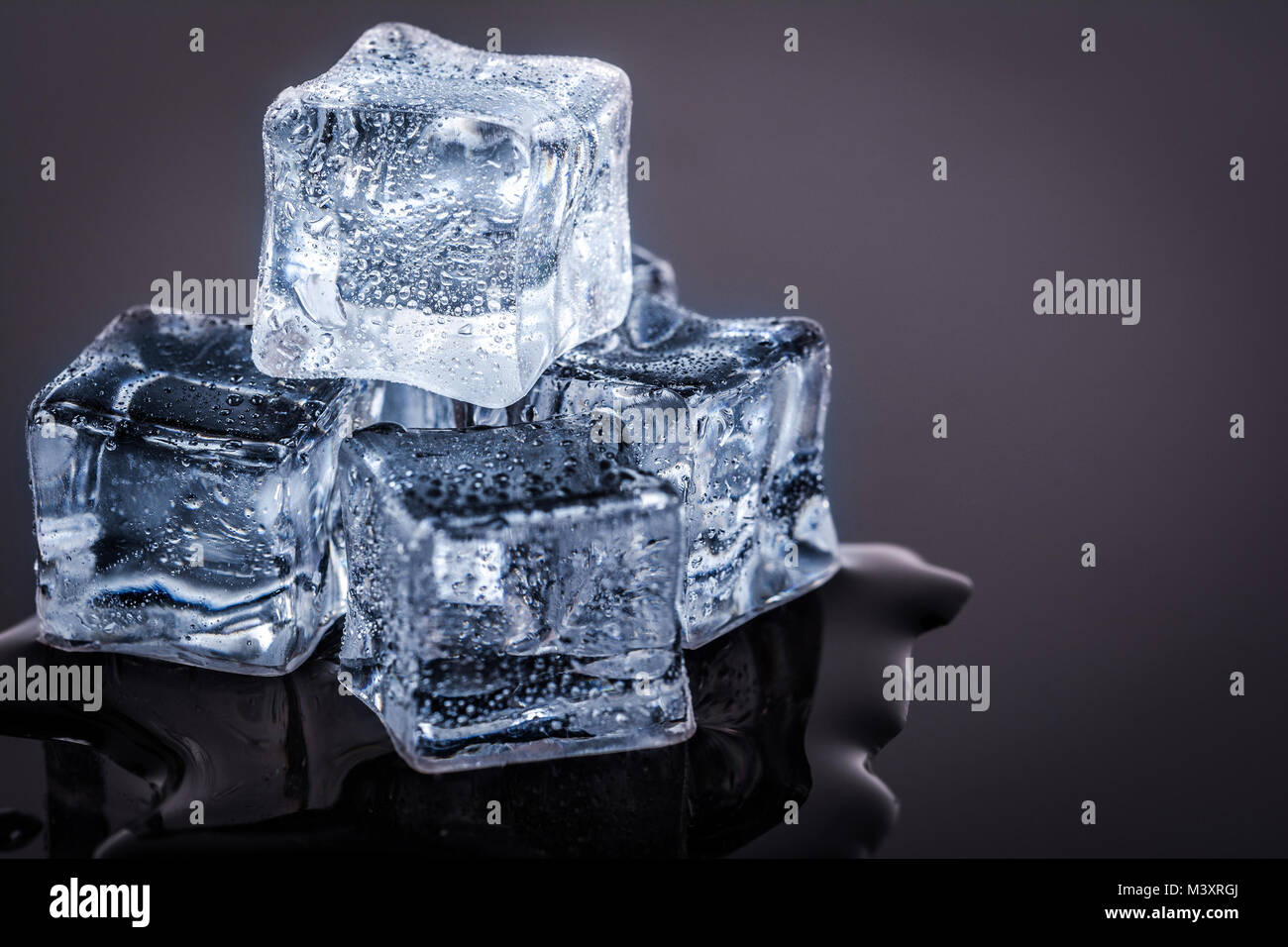 Many ice cubes on black reflection background Stock Photo - Alamy