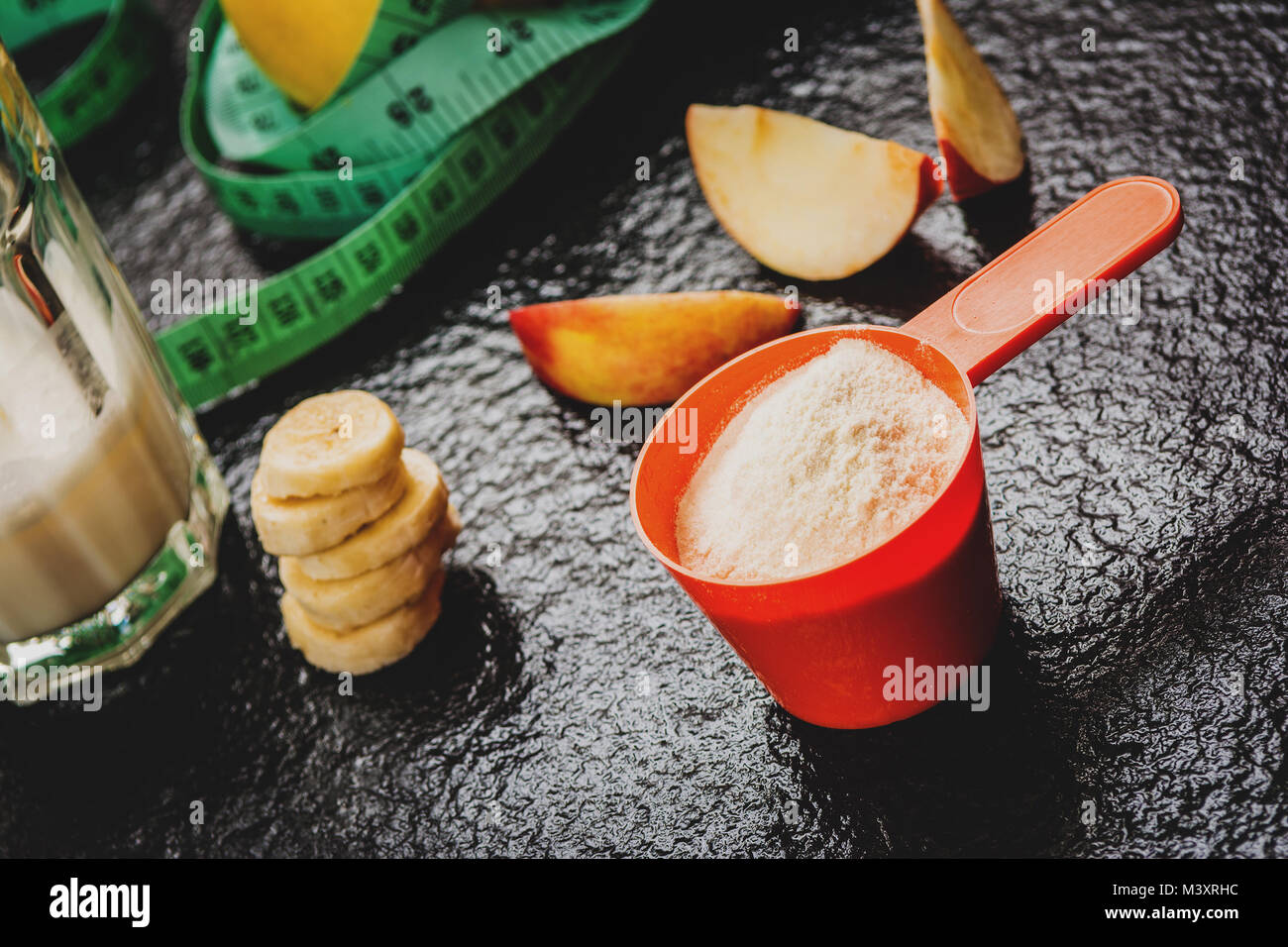 Protein powder in scoop and fruits on stone table Stock Photo - Alamy
