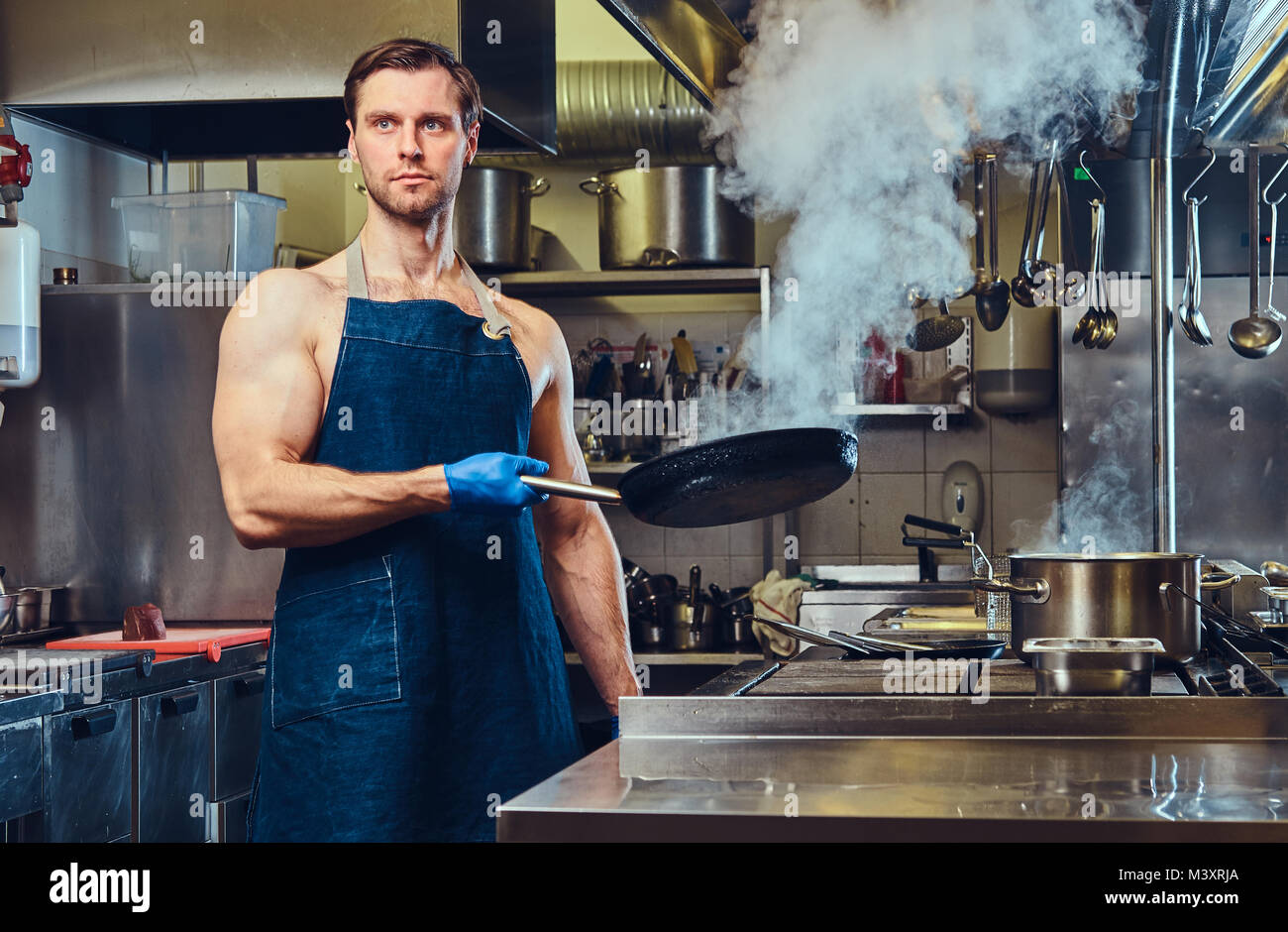 The chef holds dry pan Stock Photo - Alamy