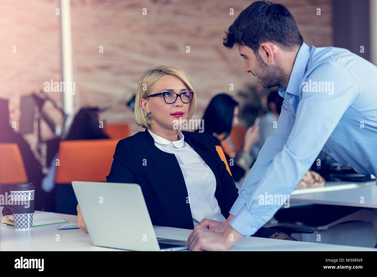 Skilled professional blonde female CEO explaining to young male ...