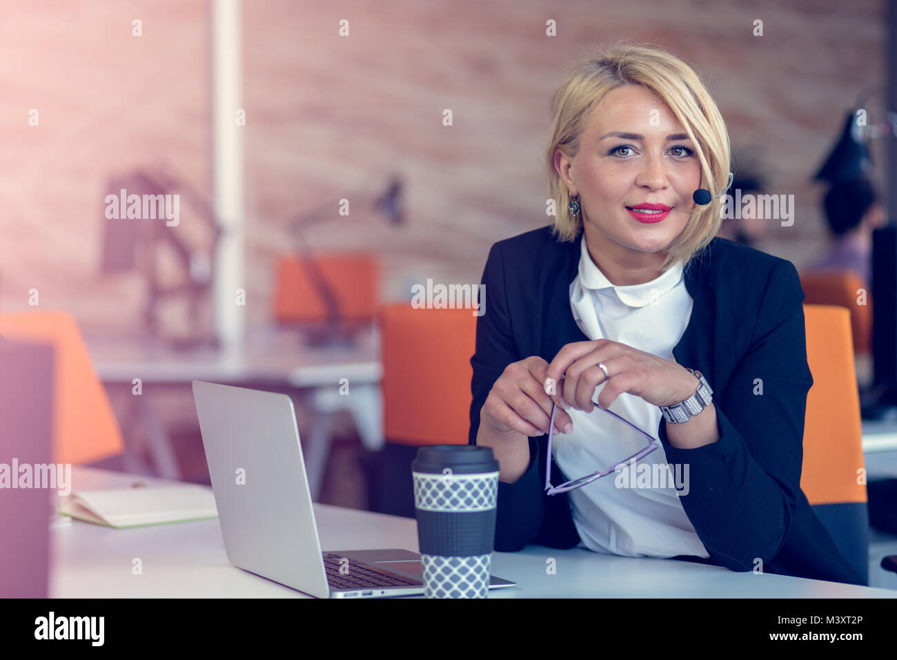 Smiling agent woman with headsets. Portrait of call center worker at ...
