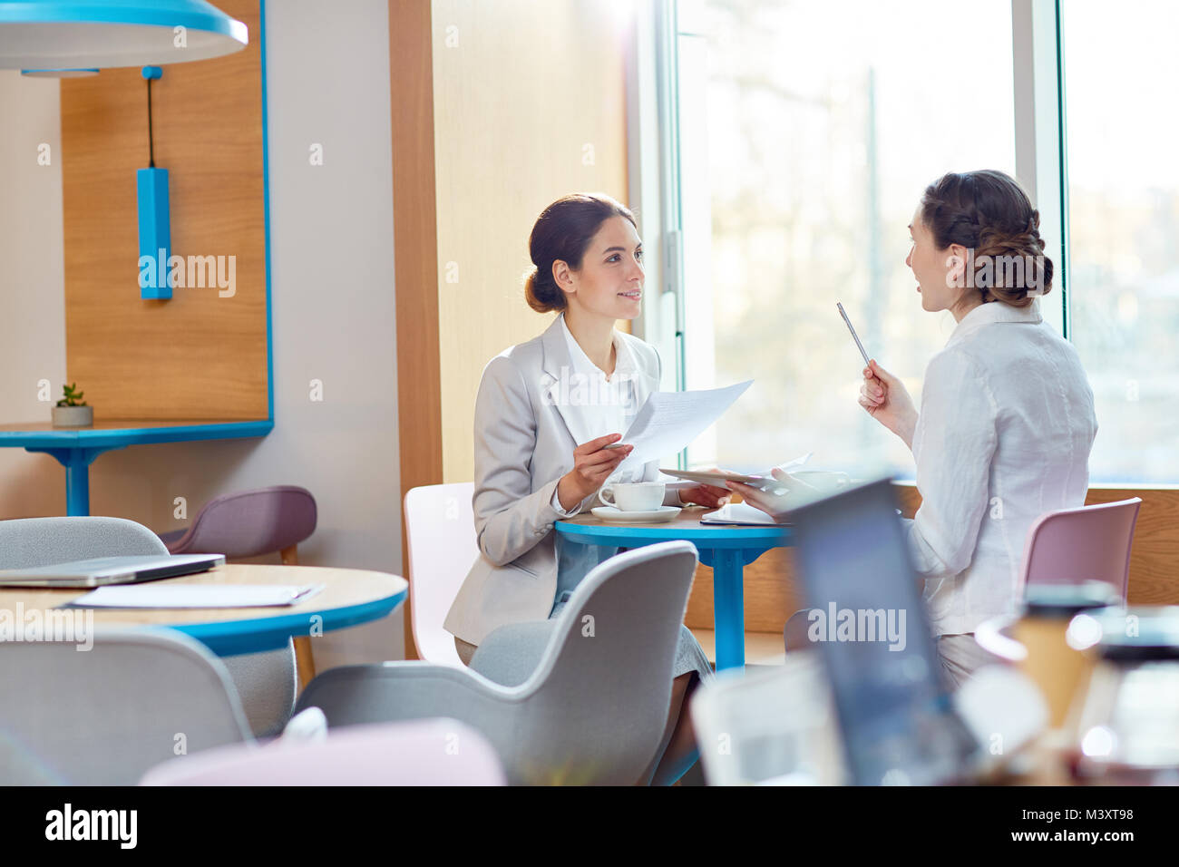 Manager discussing employee document hi-res stock photography and ...