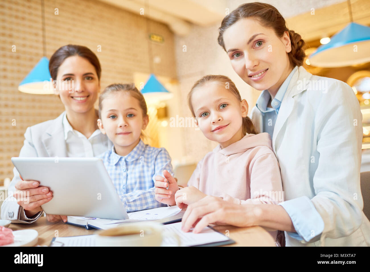 Cute girls with mothers Stock Photo - Alamy