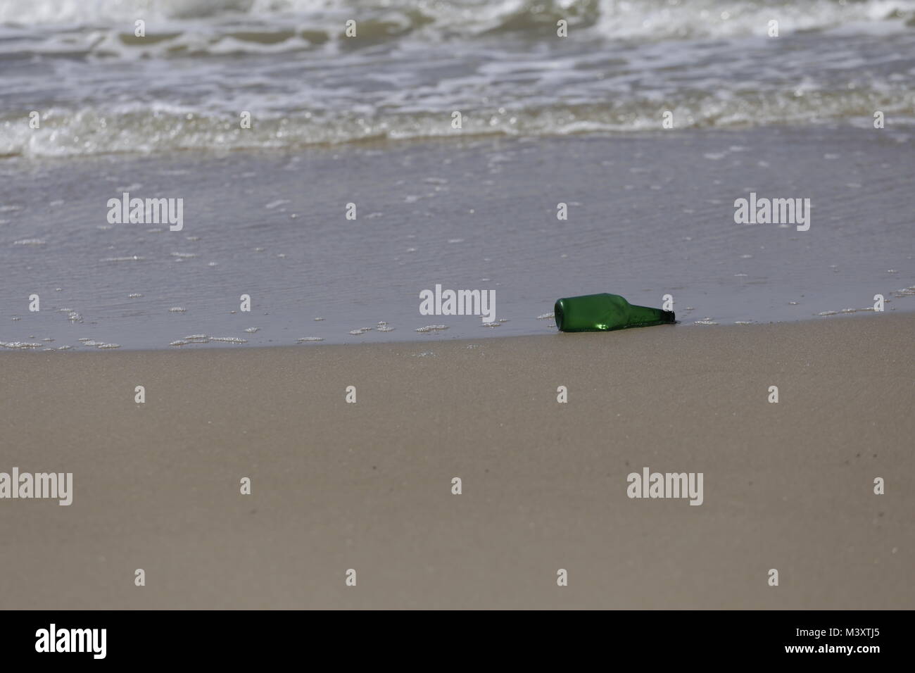 Bottle at the shore, message in a bottle Stock Photo - Alamy