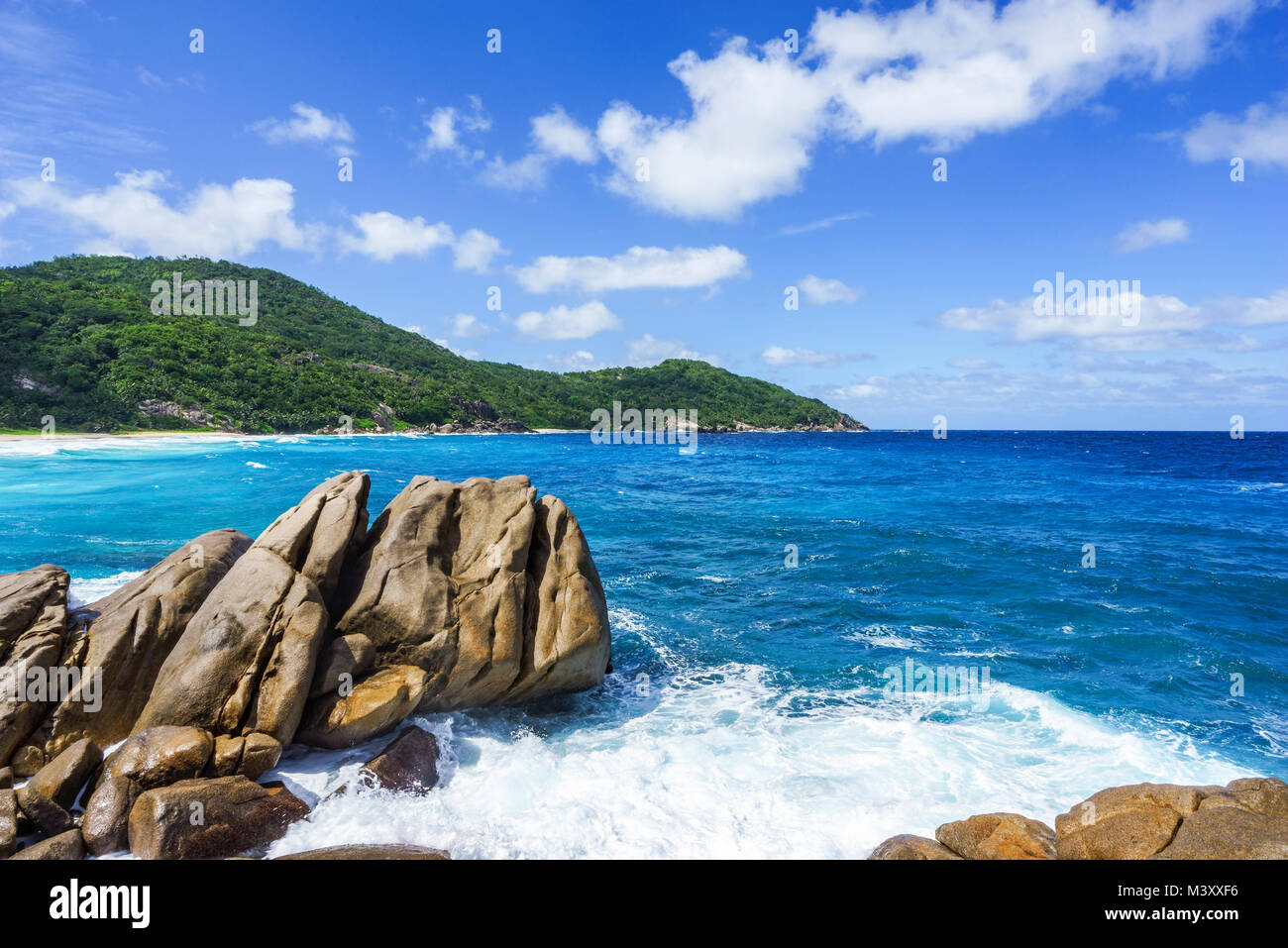 Splashing water withe big water fountains on a wild tropical beach with ...