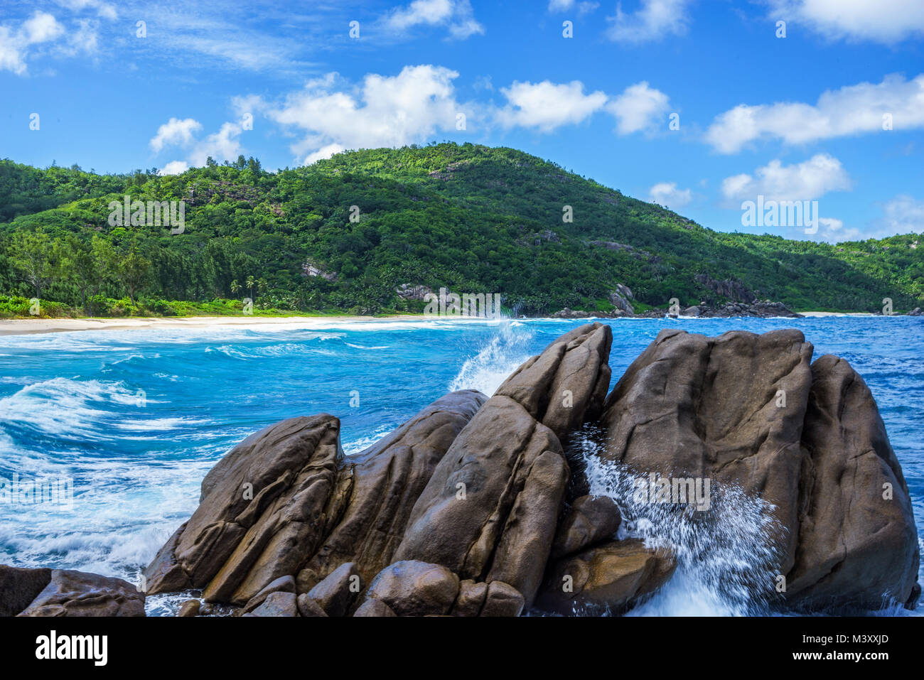 Splashing water withe big water fountains on a wild tropical beach with ...