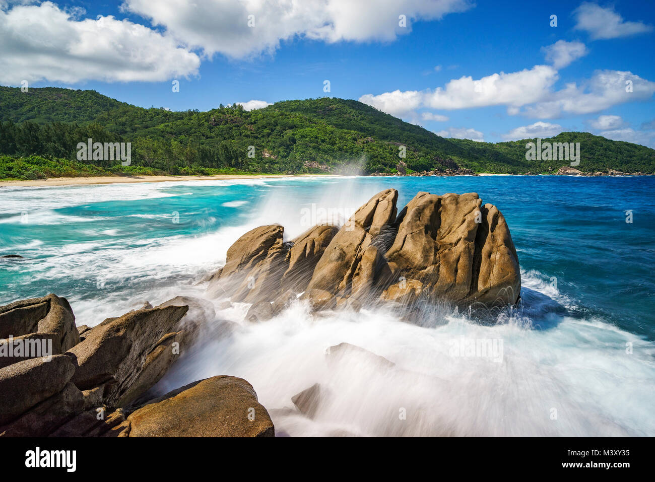 Splashing water withe big water fountains on a wild tropical beach with ...