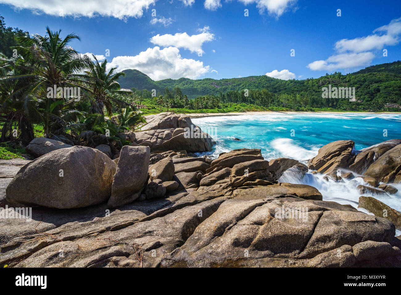 Splashing water withe big water fountains on a wild tropical beach with ...