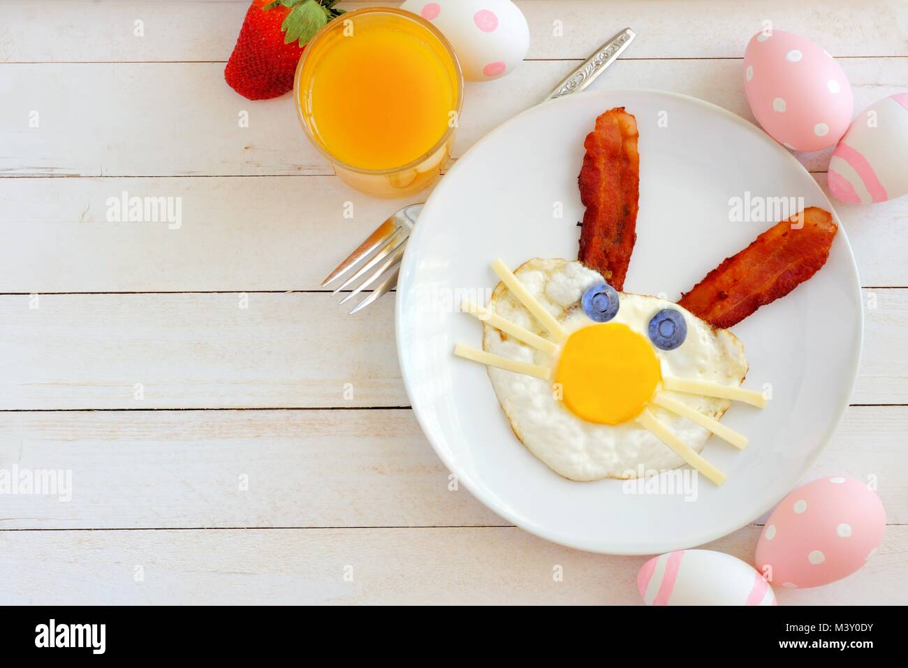 Easter breakfast with cute bunny face made of egg and bacon. Table ...