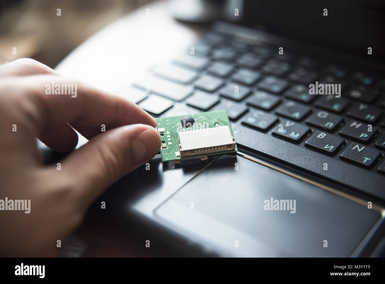 card reader in hand , laptop, keyboard information Stock Photo - Alamy