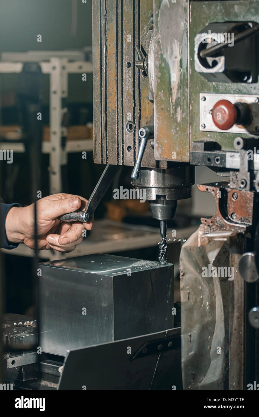 Employee drilling. Metal drilling. Metal workshop Stock Photo - Alamy