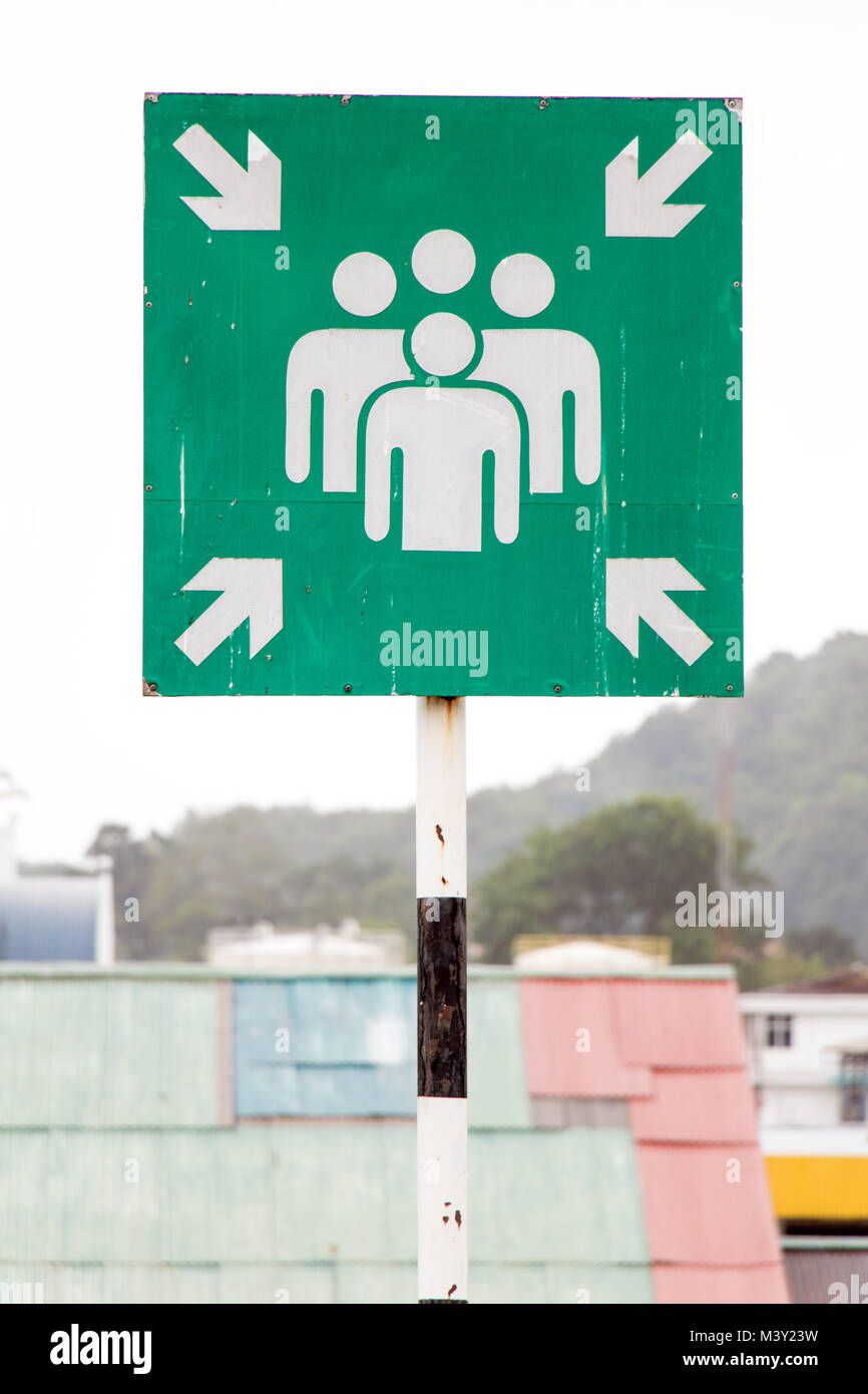 A emergency assembly point green sign outdoors. Green meeting point ...